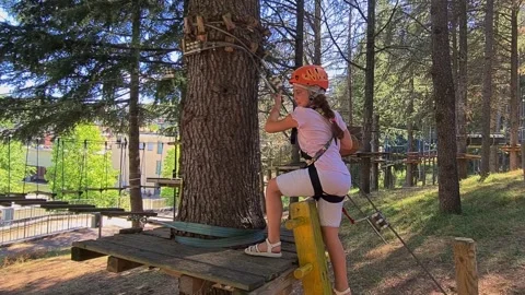 Adventurous girl child climbs at kids ro... | Stock Video | Pond5