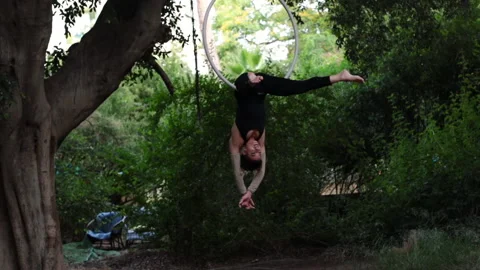 Aerial acrobat hanging upside down from ... | Stock Video | Pond5