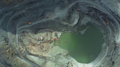 Aerial. A big open pit with a lake, road... | Stock Video | Pond5