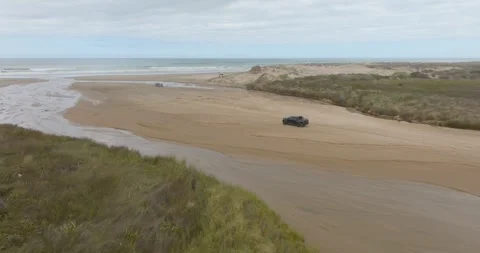Aerial: Car driving in a stream in the T... | Stock Video | Pond5