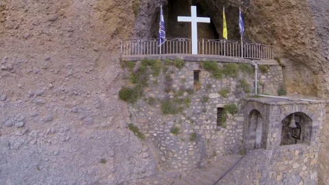 Aerial Church in cave with big cross | Stock Video | Pond5