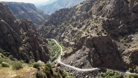 Aerial crests rocky ridge to reveal dirt... | Stock Video | Pond5