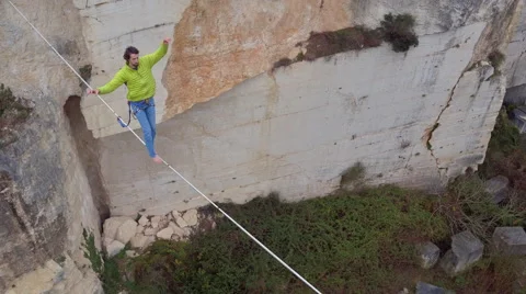 AERIAL: Fearless guy balancing on bouncy... | Stock Video | Pond5