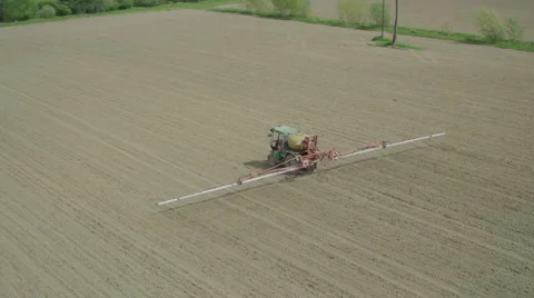 AERIAL: Flying aroung the tractor fertil... | Stock Video | Pond5