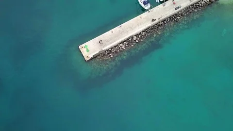 Aerial: Flying over concrete pier at sea... | Stock Video | Pond5
