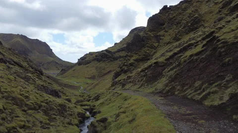 Aerial of a green rocky valley with grav... | Stock Video | Pond5
