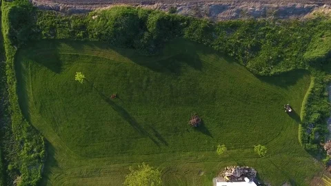 aerial lawn tractor cutting grass zoom i... | Stock Video | Pond5