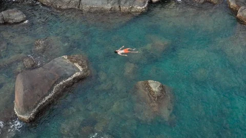 Aerial - Man Floating on back on Surface... | Stock Video | Pond5