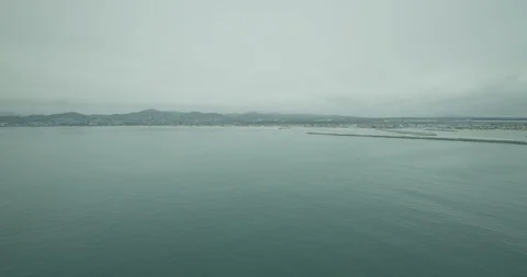 Aerial moving across ocean, shore seen i... | Stock Video | Pond5