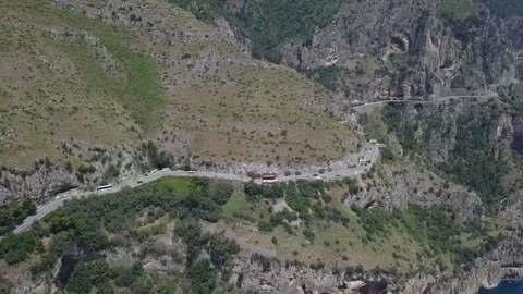 Aerial orbits vehicle traffic on cliff s... | Stock Video | Pond5