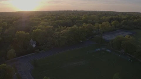 Aerial over soccer field and houses 4k | Stock Video | Pond5