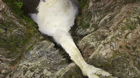 Aerial: A powerful stream of water falls... | Stock Video | Pond5