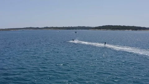 AERIAL profile shot of a jet ski pulling... | Stock Video | Pond5