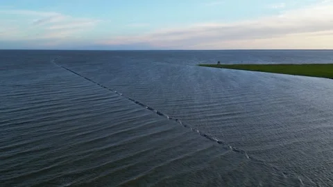Aerial rises: Small waves wash over 'Mol... | Stock Video | Pond5