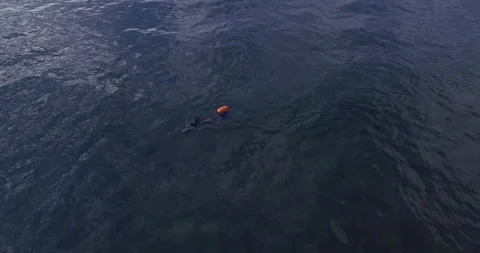 aerial rotating shot of a swimmer swims ... | Stock Video | Pond5