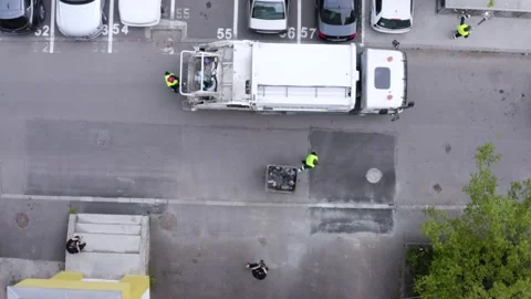 Aerial shot of garbage men with trash tr... | Stock Video | Pond5