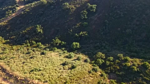 Aerial shot of hills tilting up to horiz... | Stock Video | Pond5