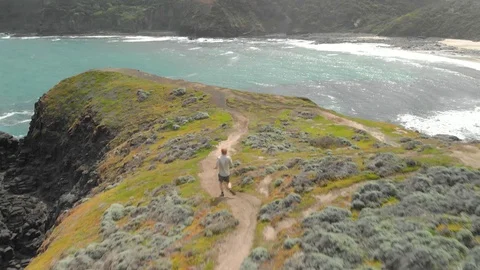 A aerial shot tracking a man running on ... | Stock Video | Pond5