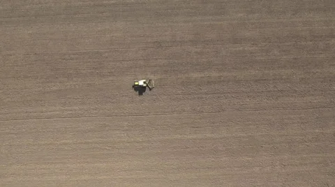Aerial shot of tractor harrow on a field | Stock Video | Pond5