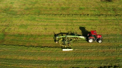 Aerial Shot of Tractor Raking Grass For ... | Stock Video | Pond5