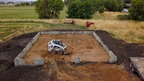 Aerial skid loader prepares building for... | Stock Video | Pond5
