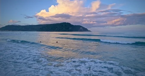 Aerial of surfers on whangamata beach at... | Stock Video | Pond5