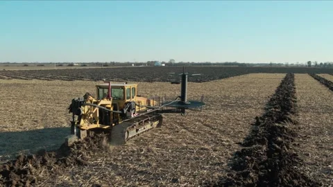 Aerial, tile plow digging line in a soil... | Stock Video | Pond5