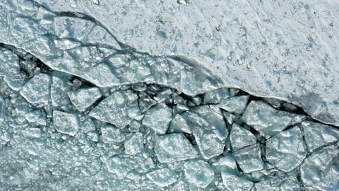 Aerial top down, cracked polar ice sheet... | Stock Video | Pond5