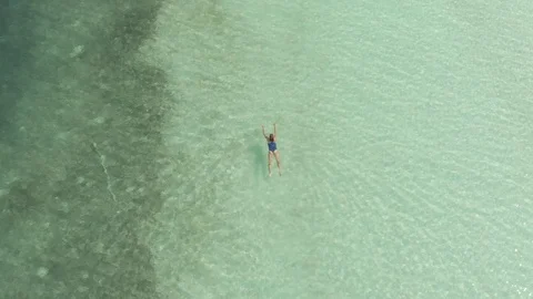 Aerial top down: Woman swimming in turqu... | Stock Video | Pond5