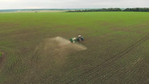 Aerial top view of farming tractor plowi... | Stock Video | Pond5