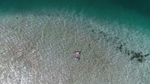 Aerial top view turn over couple float o... | Stock Video | Pond5