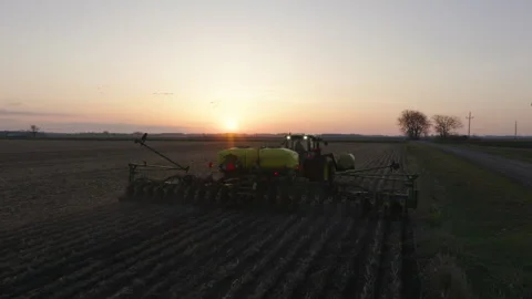 Aerial, tractor plowing farm field with ... | Stock Video | Pond5