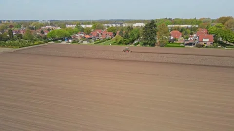 Aerial of tractor plowing a plot of dir... | Stock Video | Pond5