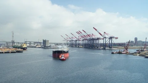 Aerial of tugboat pulling cargo ship awa... | Stock Video | Pond5