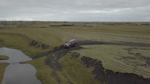 Aerial video of 4x4 car driving trough w... | Stock Video | Pond5