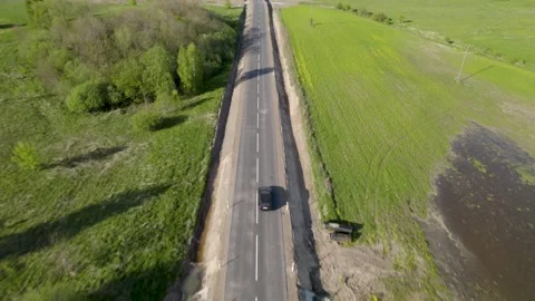 Aerial View: Black Car Driving on Daylit... | Stock Video | Pond5