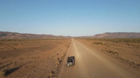 Aerial view of car driving on sandy road... | Stock Video | Pond5