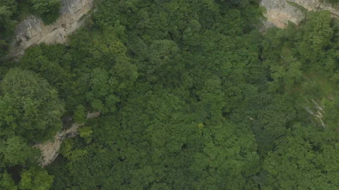 Aerial view Flying above a large rock fo... | Stock Video | Pond5