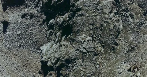Aerial view of man running across rocky ... | Stock Video | Pond5