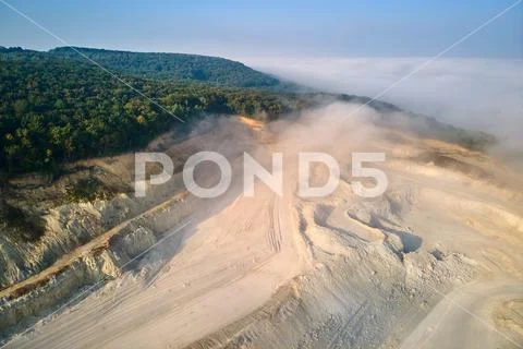 Aerial view of open pit mining site of limestone materials extraction ...