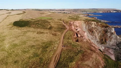 Aerial view of path next to cliffside on... | Stock Video | Pond5