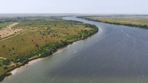 Aerial view: plain, boat goes along the ... | Stock Video | Pond5
