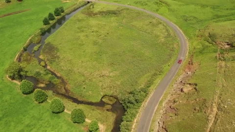 Aerial View Of Red Car Driving Round Cor... | Stock Video | Pond5