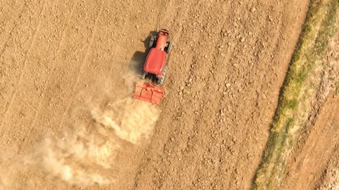 An aerial view shows a red tractor pulli... | Stock Video | Pond5