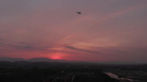 Aerial view of sunrise, a plane crossing... | Stock Video | Pond5
