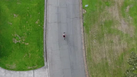 Aerial View of Woman Riding Her Bike in ... | Stock Video | Pond5