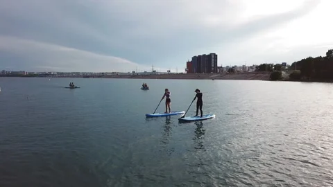 AERIAL: Young couple and a friend meetin... | Stock Video | Pond5