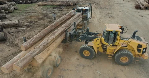 Aerial.Front-end loader hauling hardwood... | Stock Video | Pond5