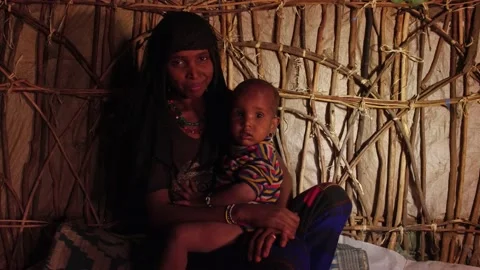 Afar tribe mother with her child in a hu... | Stock Video | Pond5