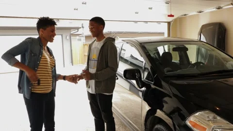 Affectionate mother giving car keys to e... | Stock Video | Pond5